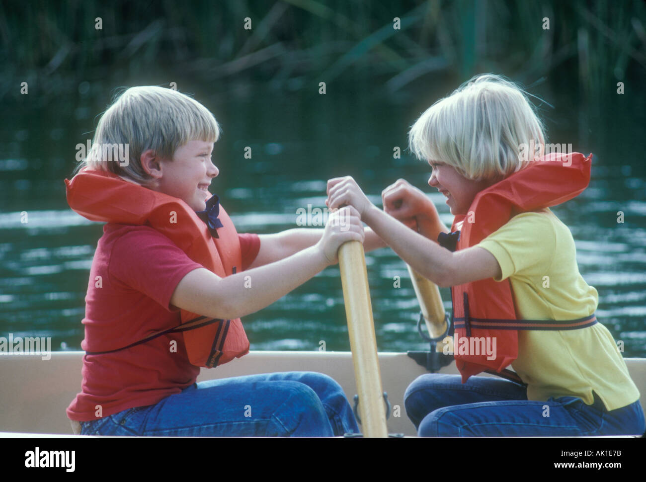 small boy and girl rowing boat Stock Photo - Alamy