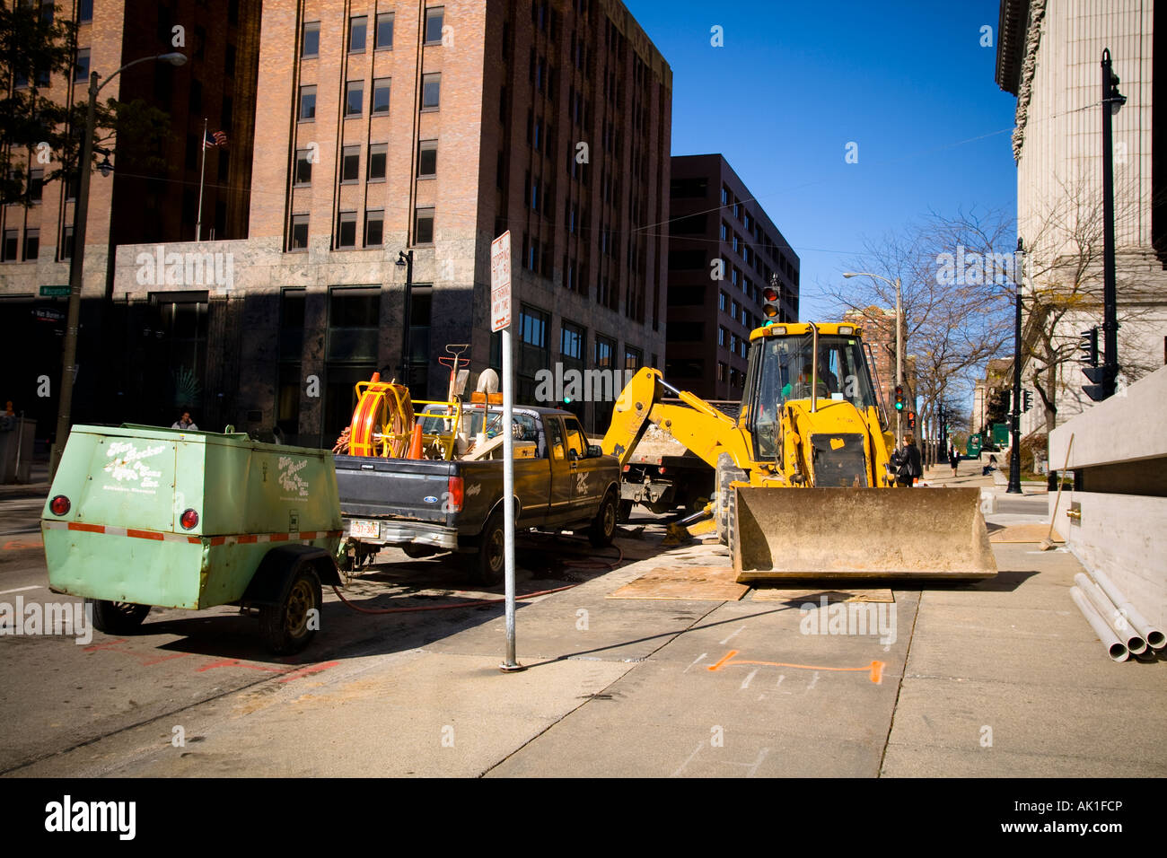 Construction workers digging on a busy street Stock Photo - Alamy