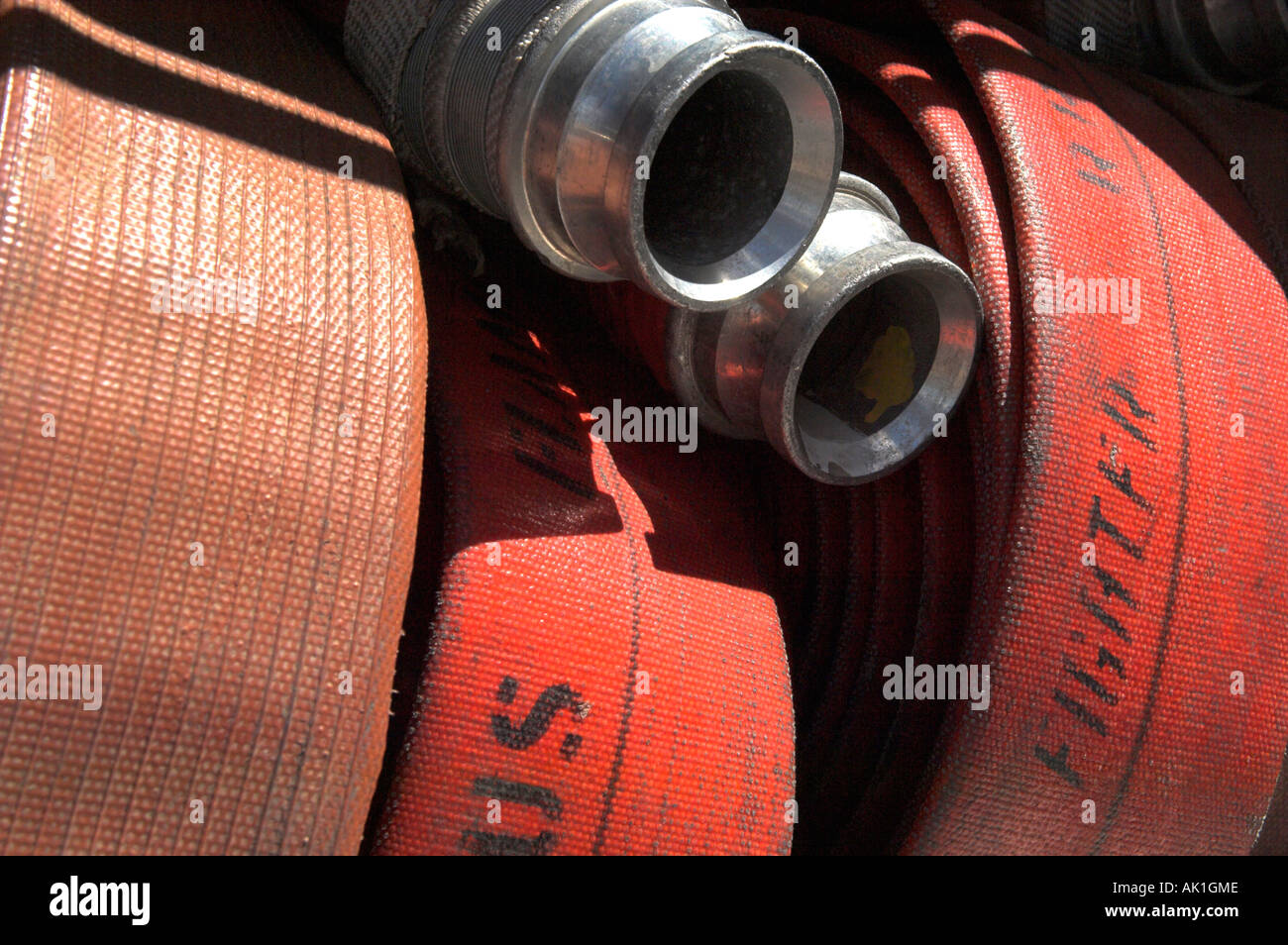 Closeup of coiled fire hose Stock Photo - Alamy