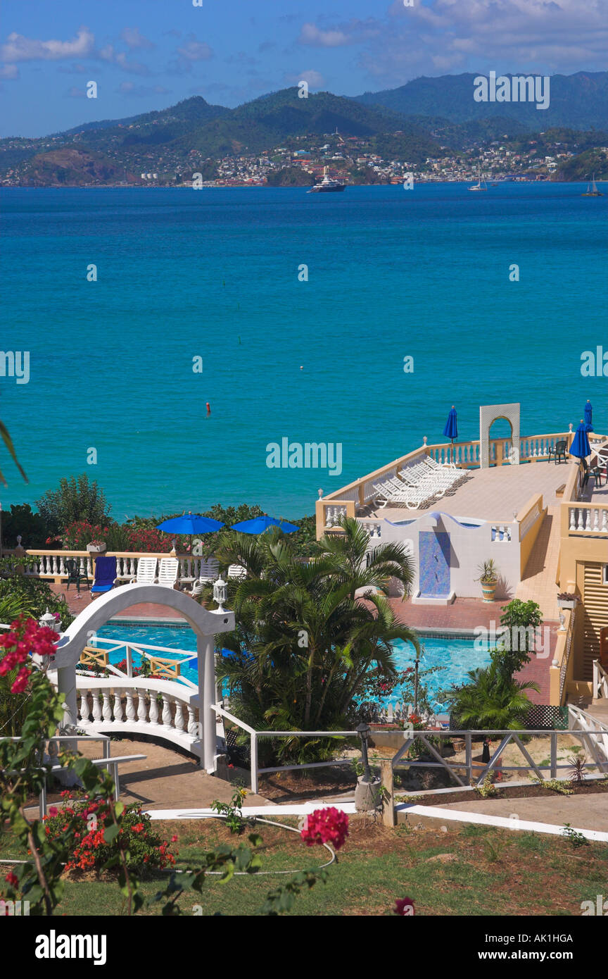 Caribbean resort with pool and sea behind Flamboyant Hotel in Grand ...