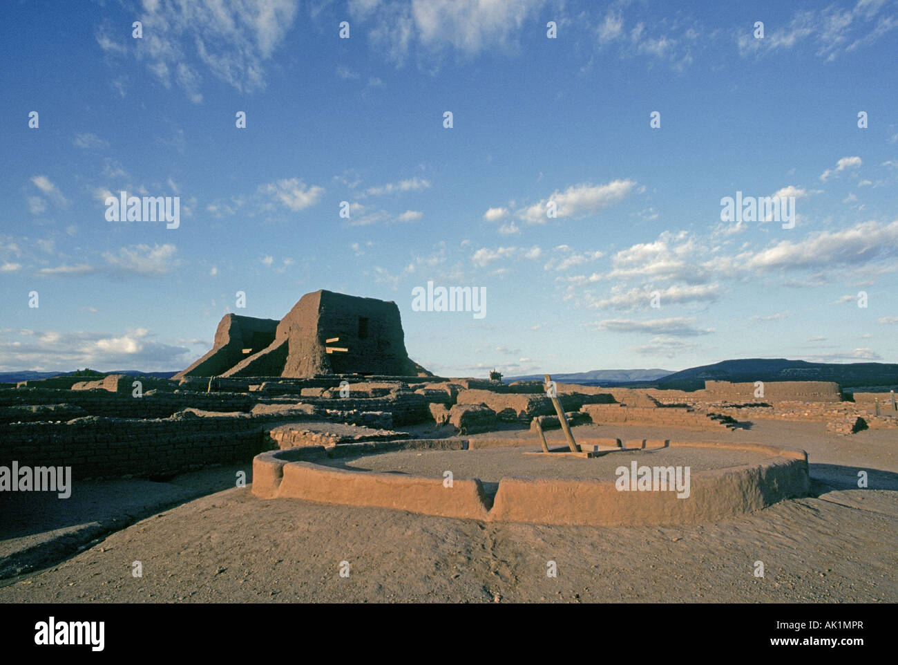 A view of an Anasazi Kiva and the old Spanish mission at the Anasazi ...