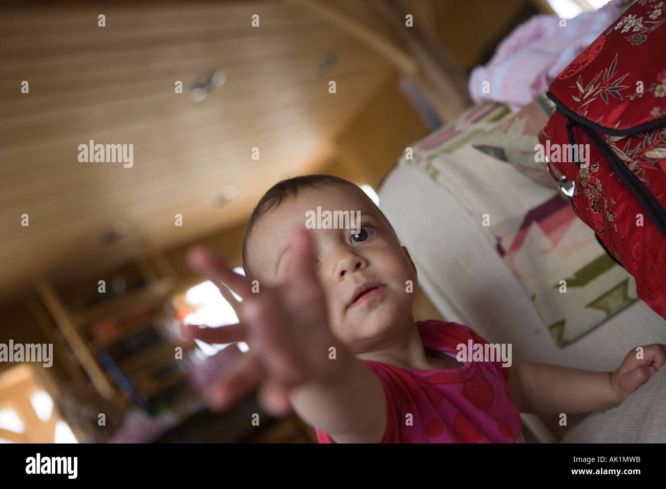 child reaching for camera in living room Stock Photo - Alamy