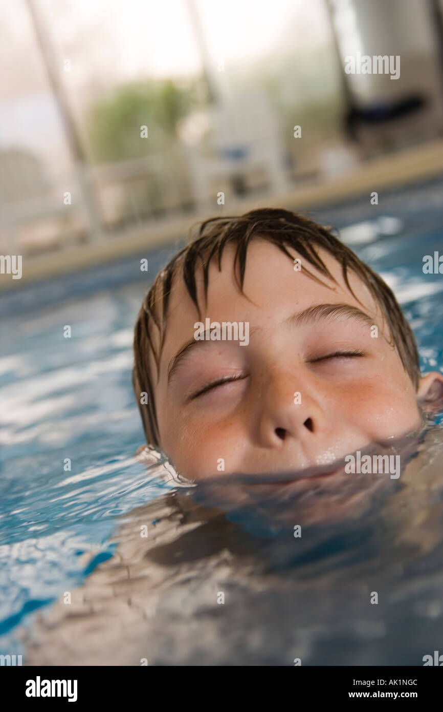 seven year old boy holding breath in pool Stock Photo - Alamy