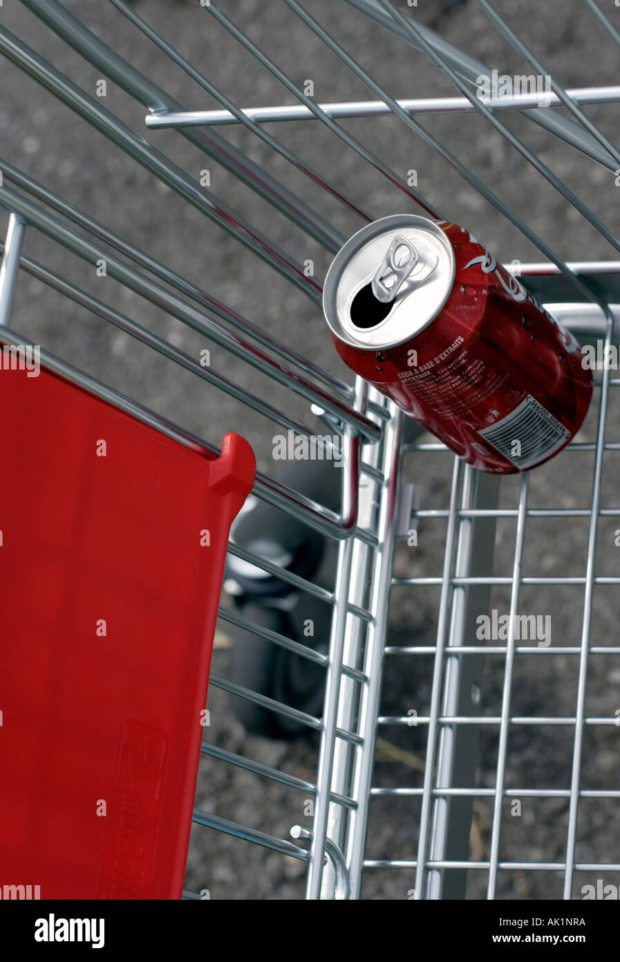 Oblique view of empty Coca Cola can in a supermarket shopping cart ...