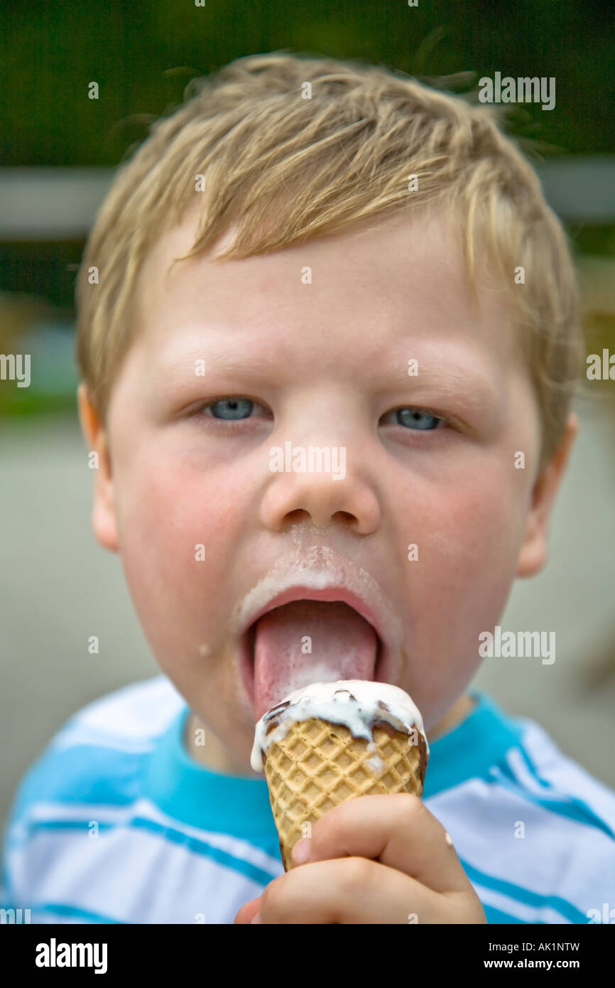 Young boy eating ice cream cone Stock Photo - Alamy