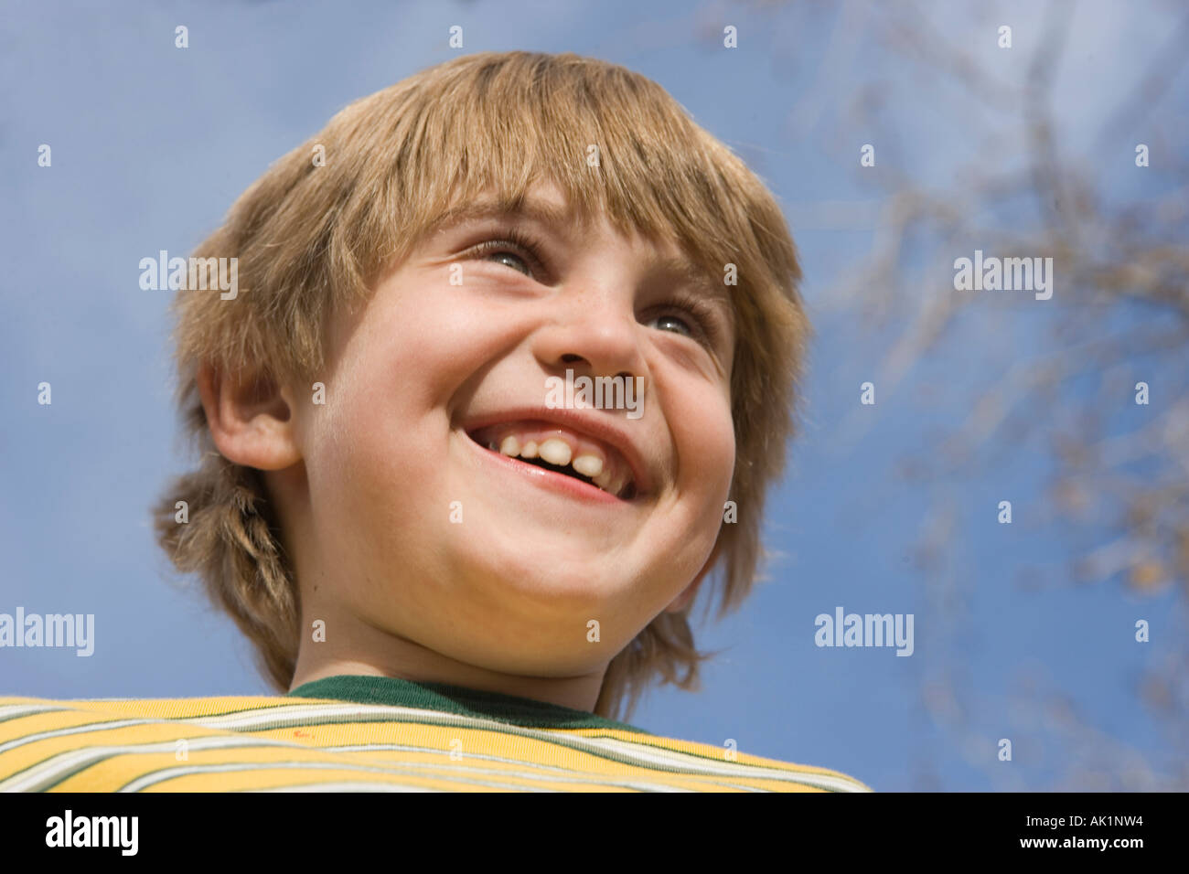 portrait of seven year old boy smiling with blue sky Stock Photo - Alamy