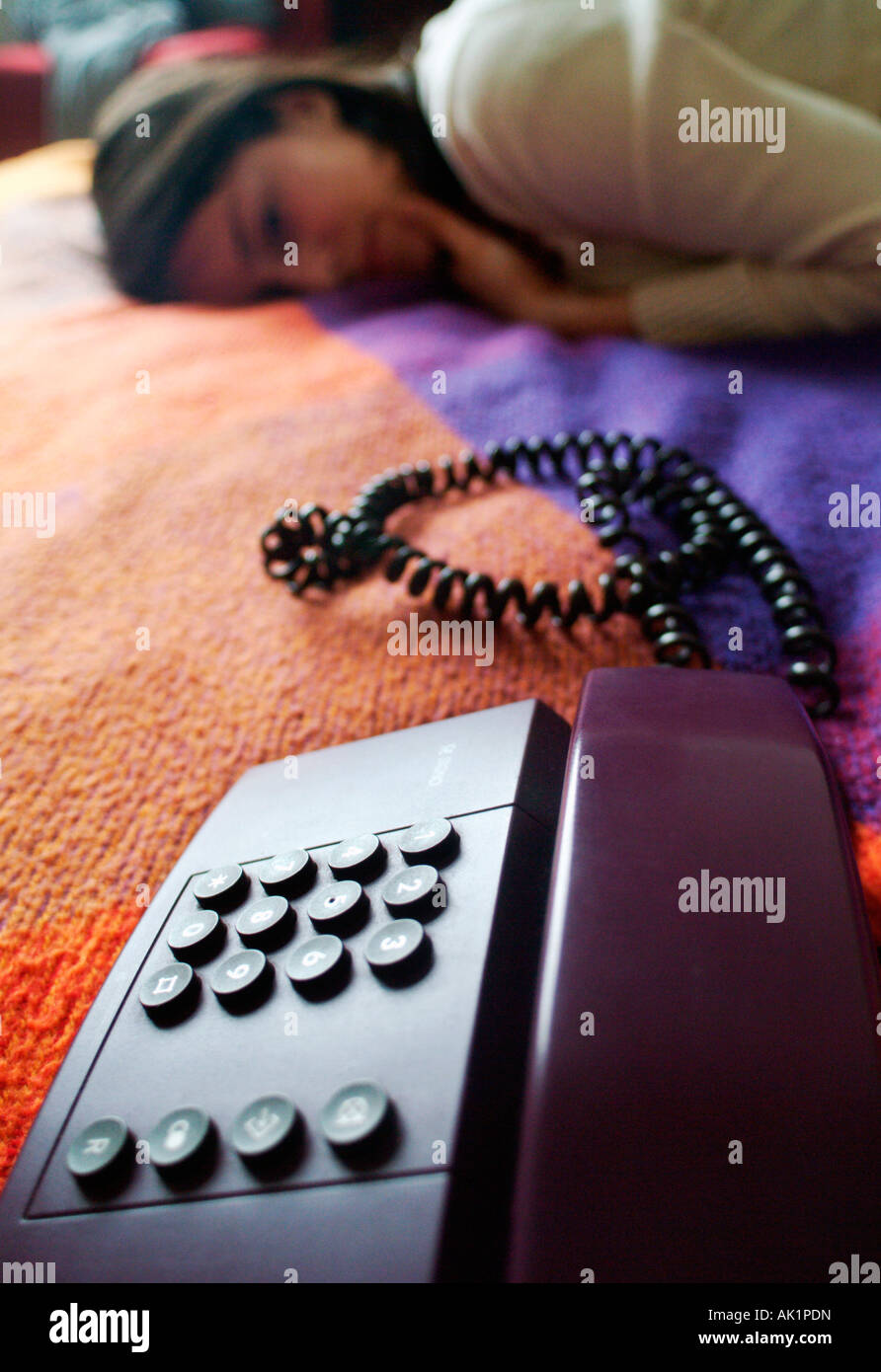 Young woman waiting on a phone call Stock Photo - Alamy