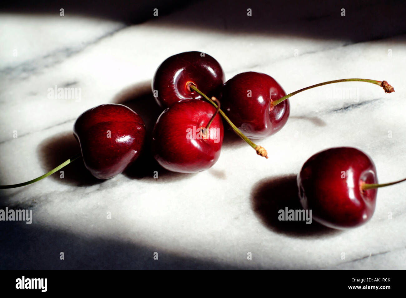 Wild cherries on a marble surface Stock Photo - Alamy
