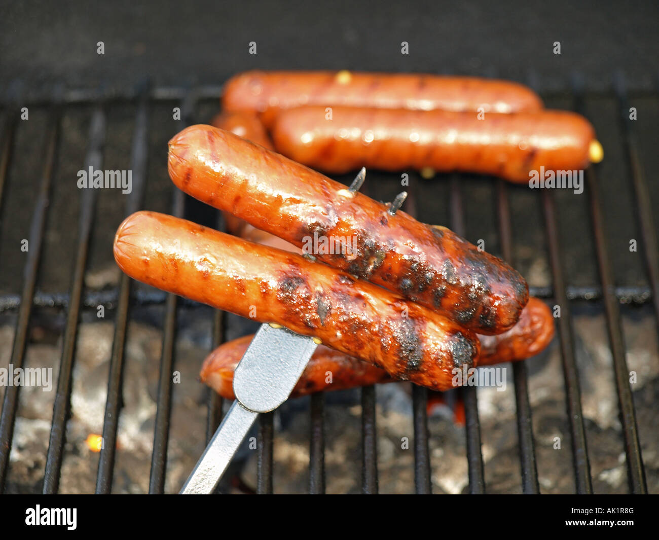 Hot dogs roast on an outdoor grill during a summer barbecue Stock Photo ...