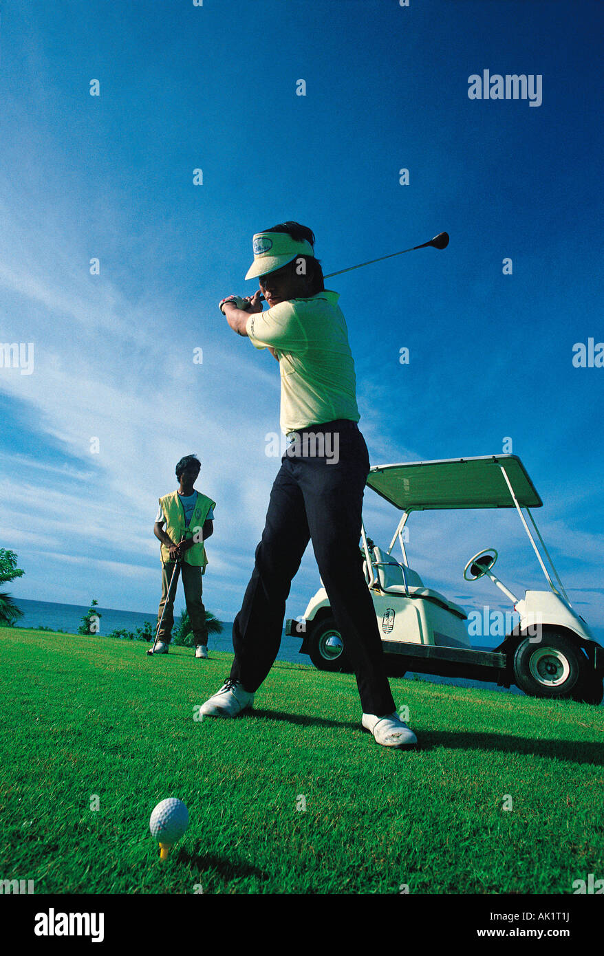 Philippines. Luzon. Bataan. Anvaya Cove. Men playing golf Stock Photo ...