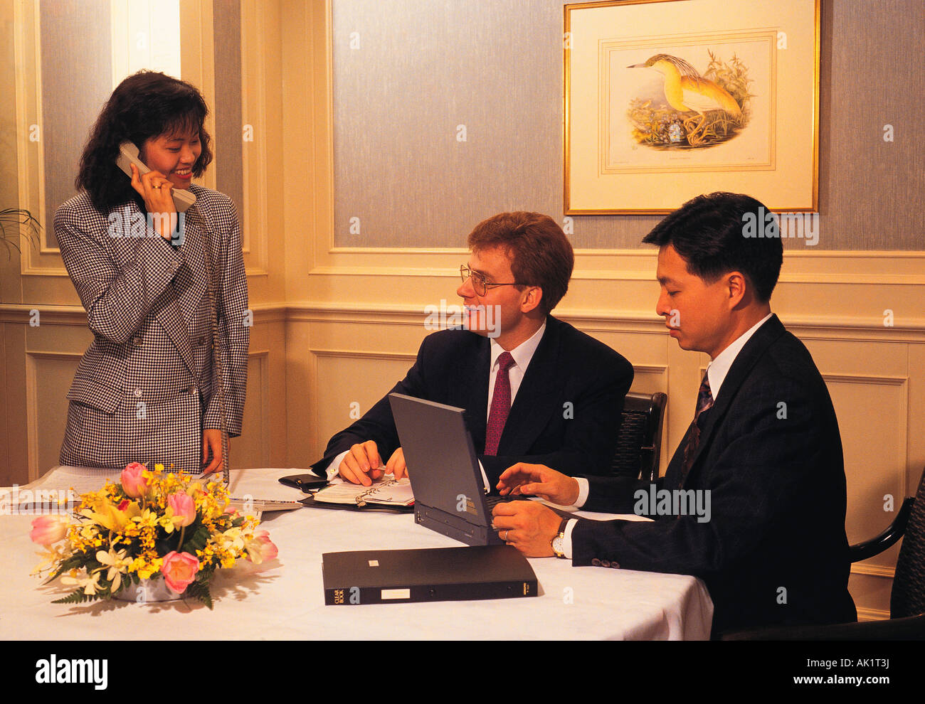 Three people in office meeting Stock Photo - Alamy