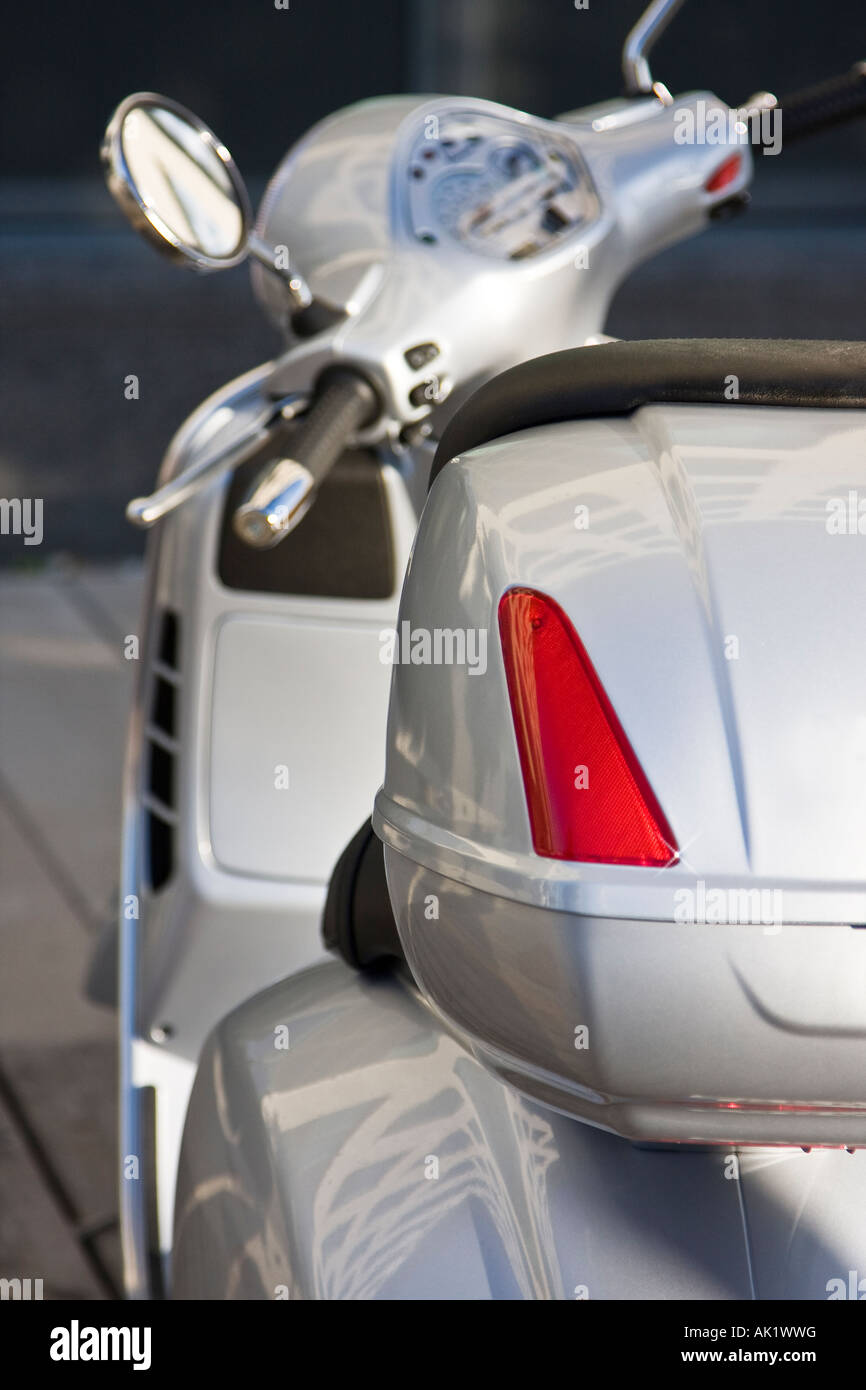Nice gray scooter with red light on its packbox Stock Photo - Alamy