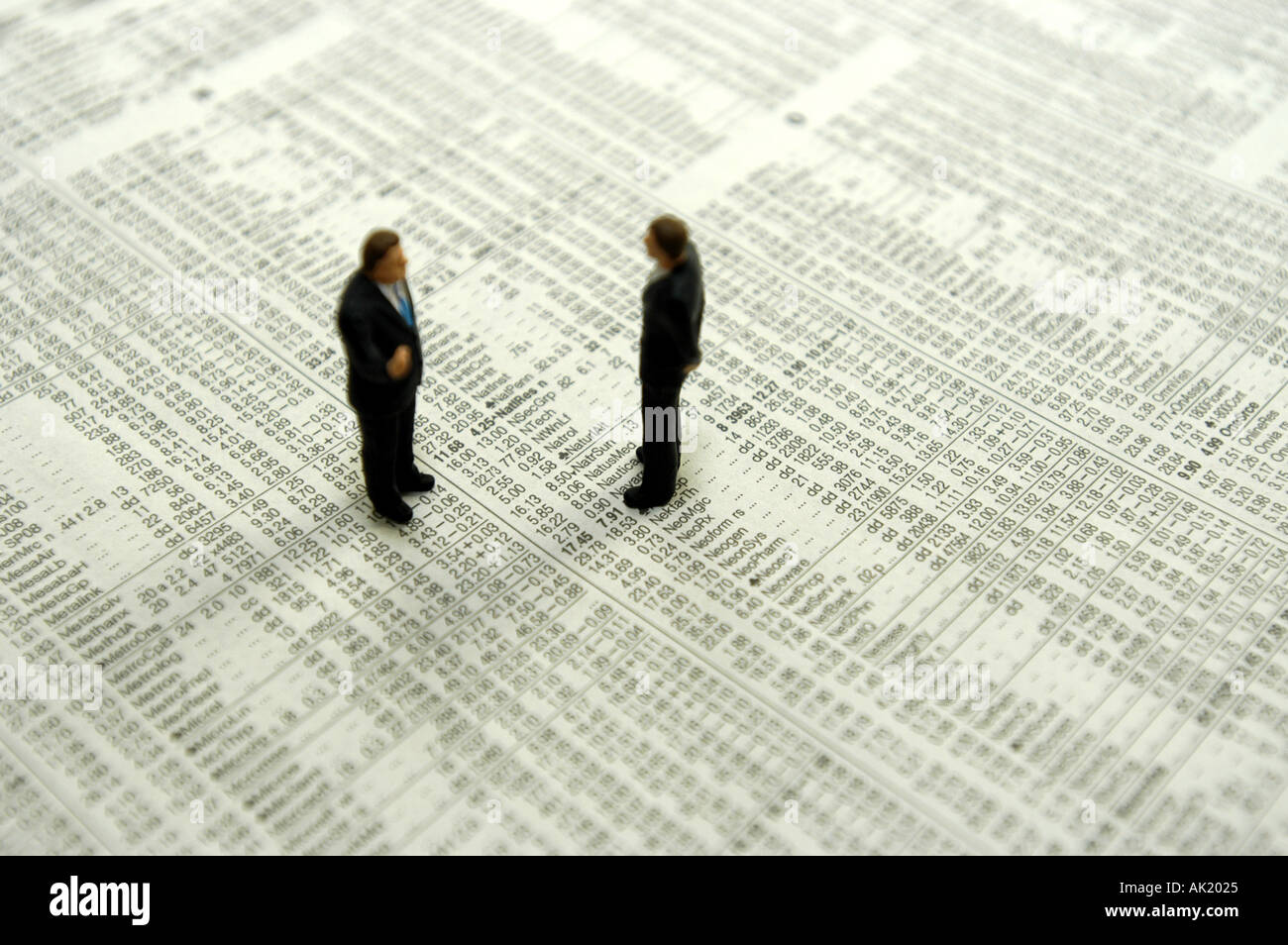 Miniature businessmen on stock market page Wall Street Journal ...
