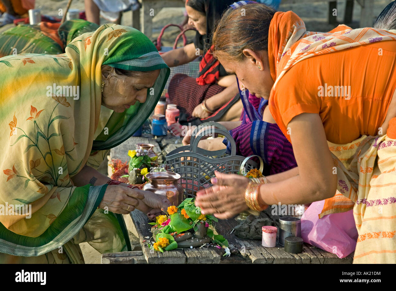 Women preparing a puja ceremony. Tulsi ghat. Ganges river. Varanasi ...