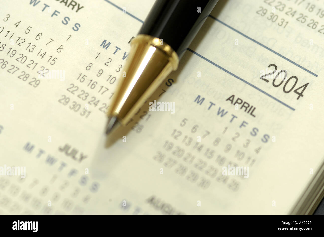 Pen tip on 2004 monthly calendar Stock Photo - Alamy