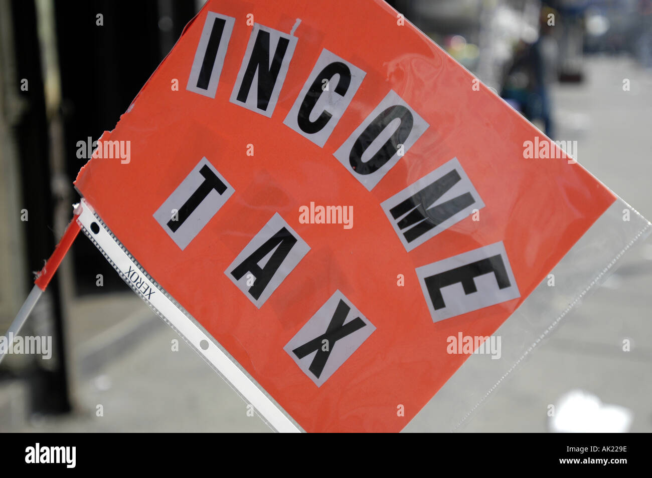 Income Tax all capitals orange banner horizontal Stock Photo - Alamy