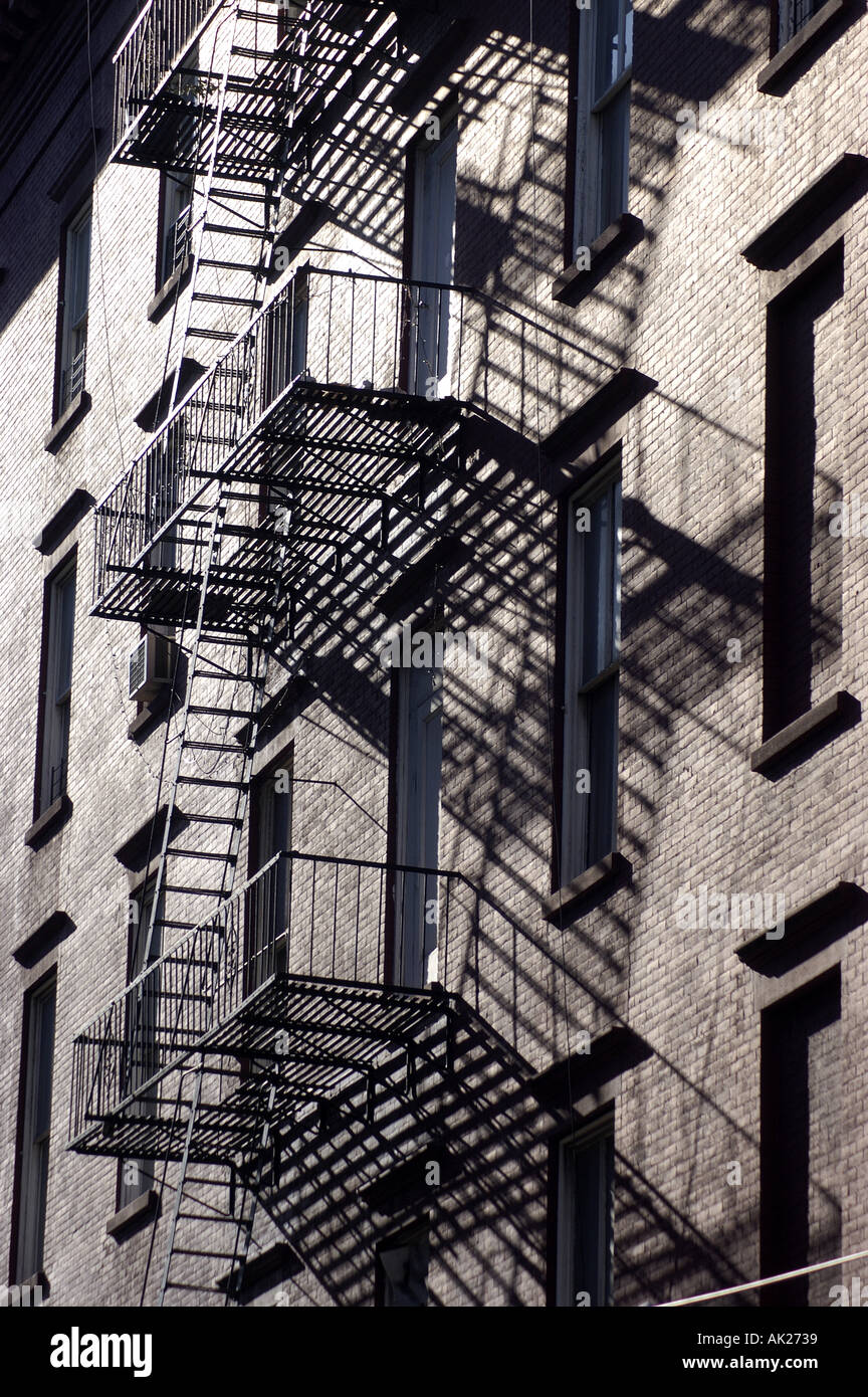 NY Fire escape metal stairs building windows vertical Stock Photo - Alamy
