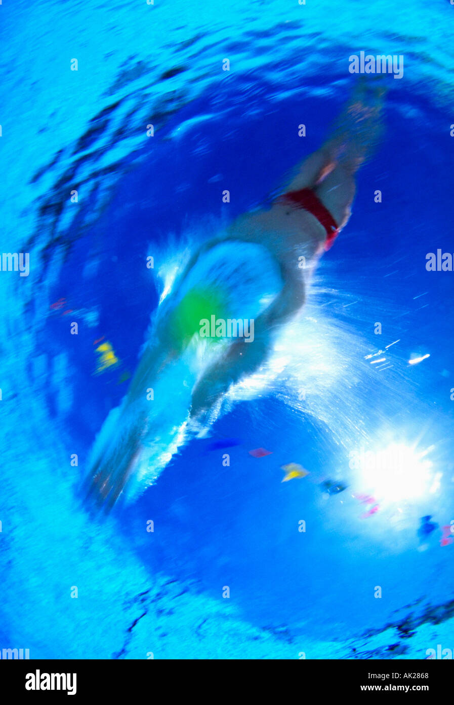 A swimmer diving into a pool of water Stock Photo - Alamy