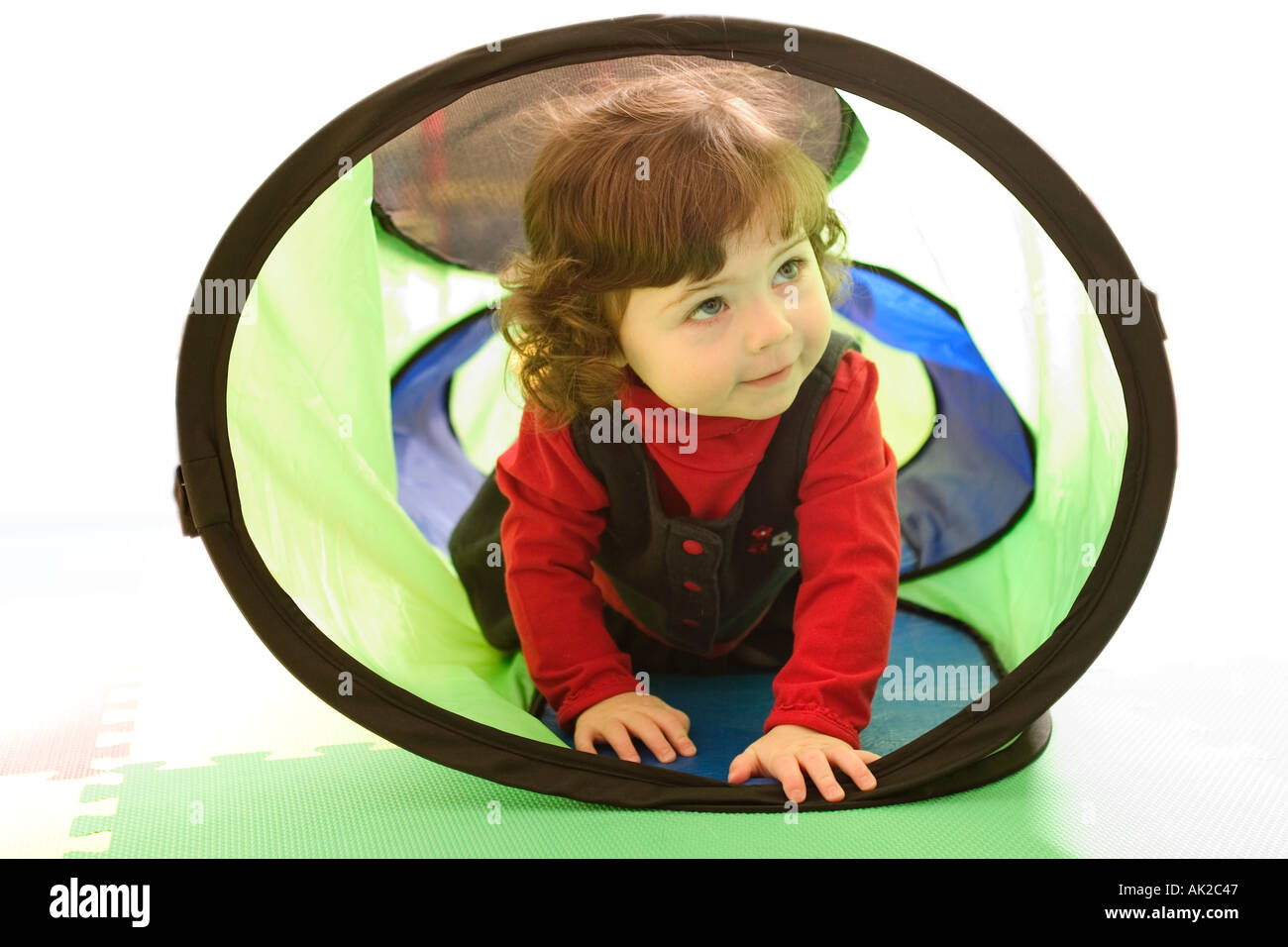 Child crawling through play tunnel hi-res stock photography and images ...