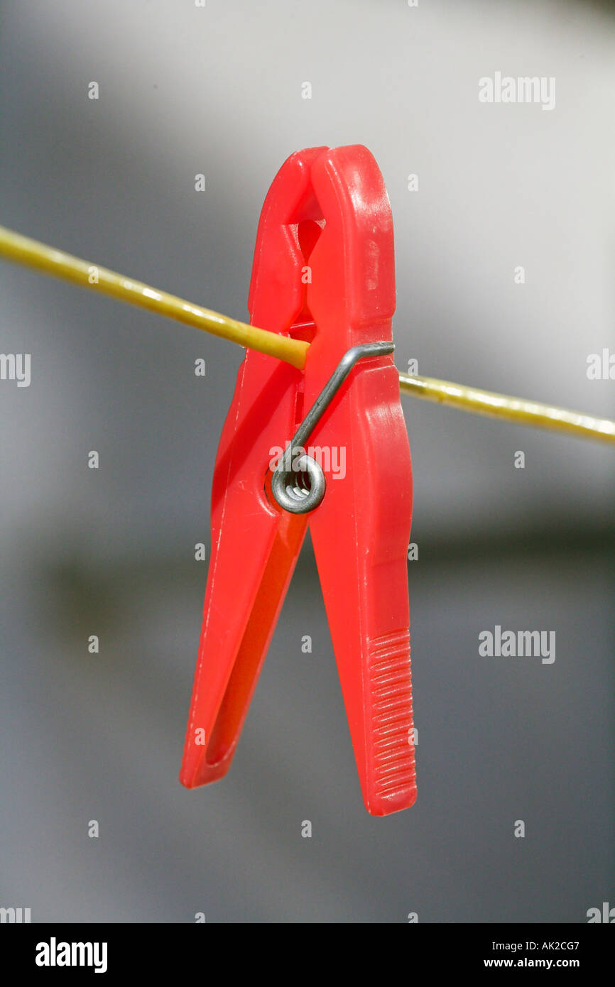 red clothes pin on yellow clothes line, close up Stock Photo - Alamy