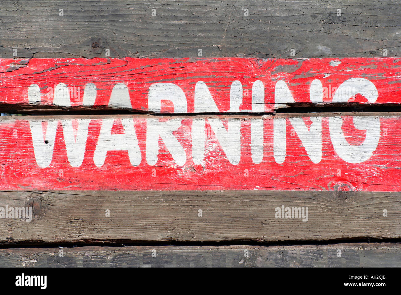 wooden warning sign with the word warning Stock Photo - Alamy