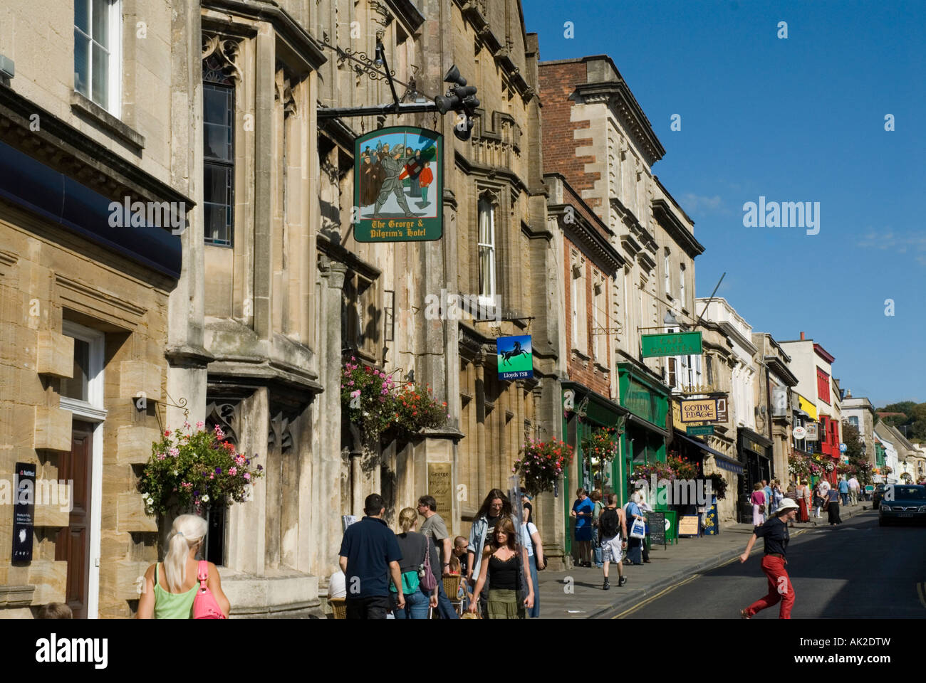 Town centre high street Glastonbury with funky shops Somerset England ...