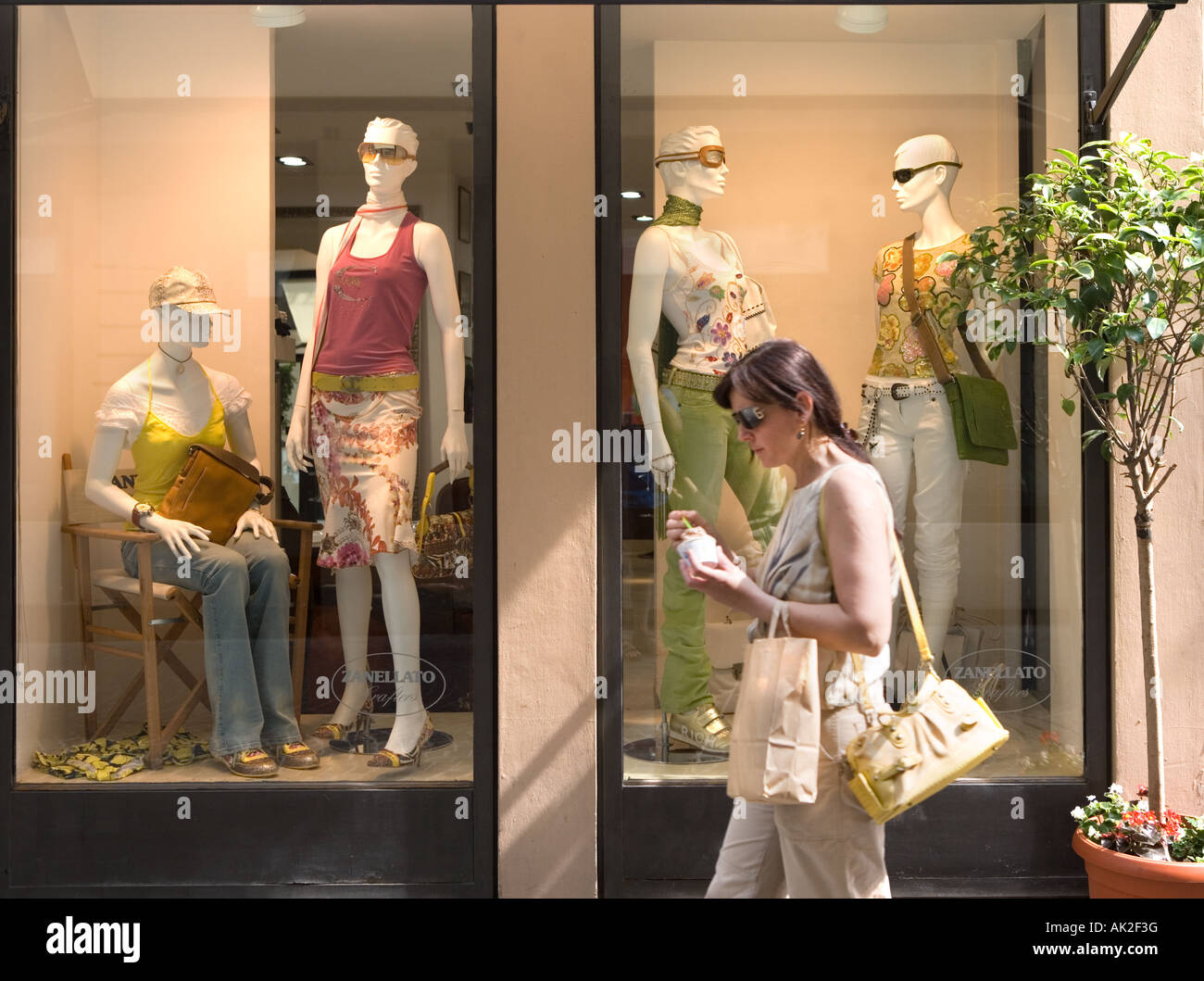 Woman walking past shop display Vicenza Veneto Italy Stock Photo - Alamy