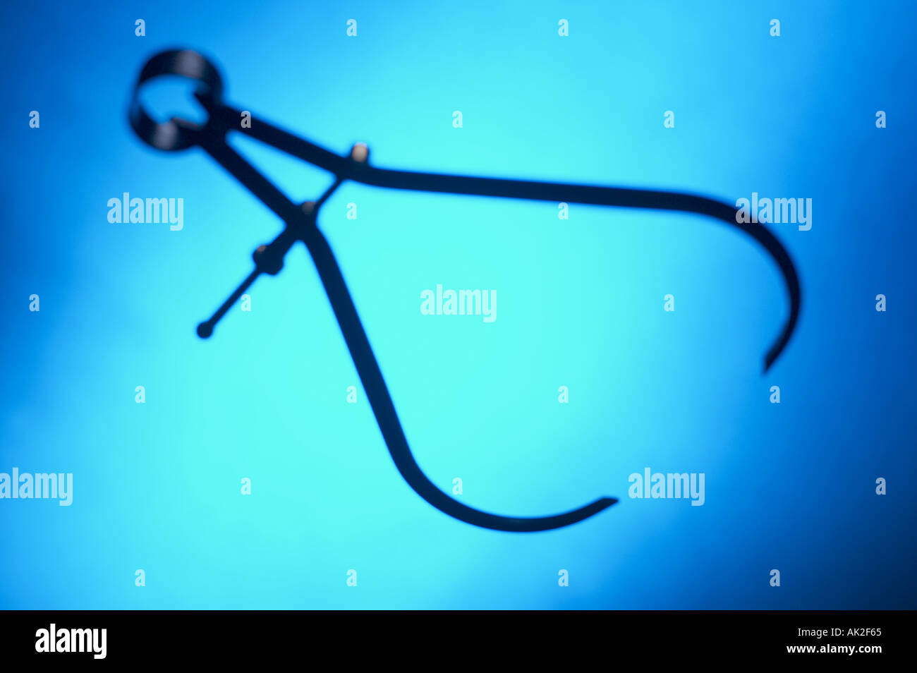 Metal caliper against blue background Stock Photo - Alamy