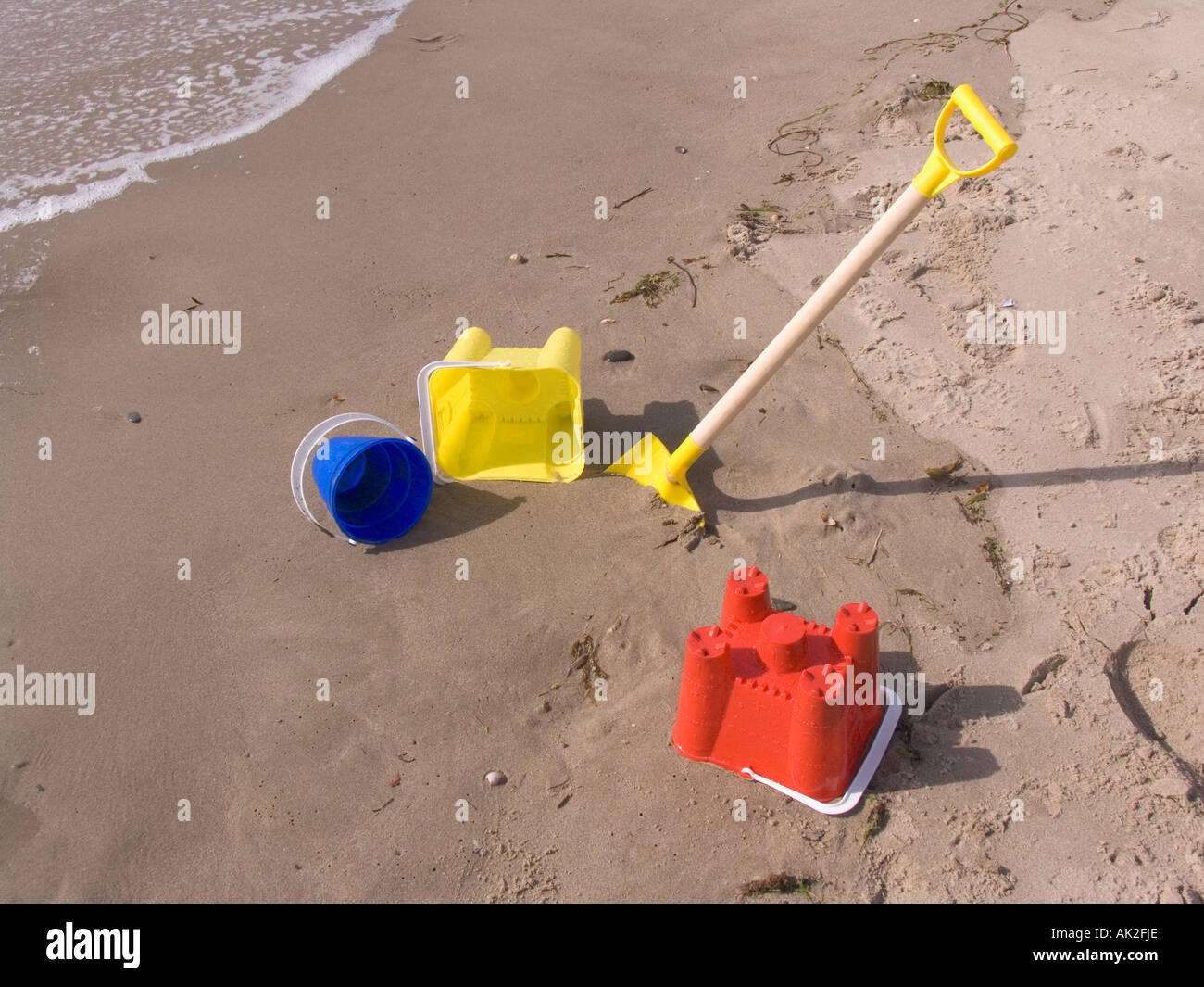 Buckets and spades on a sandy beach Stock Photo - Alamy