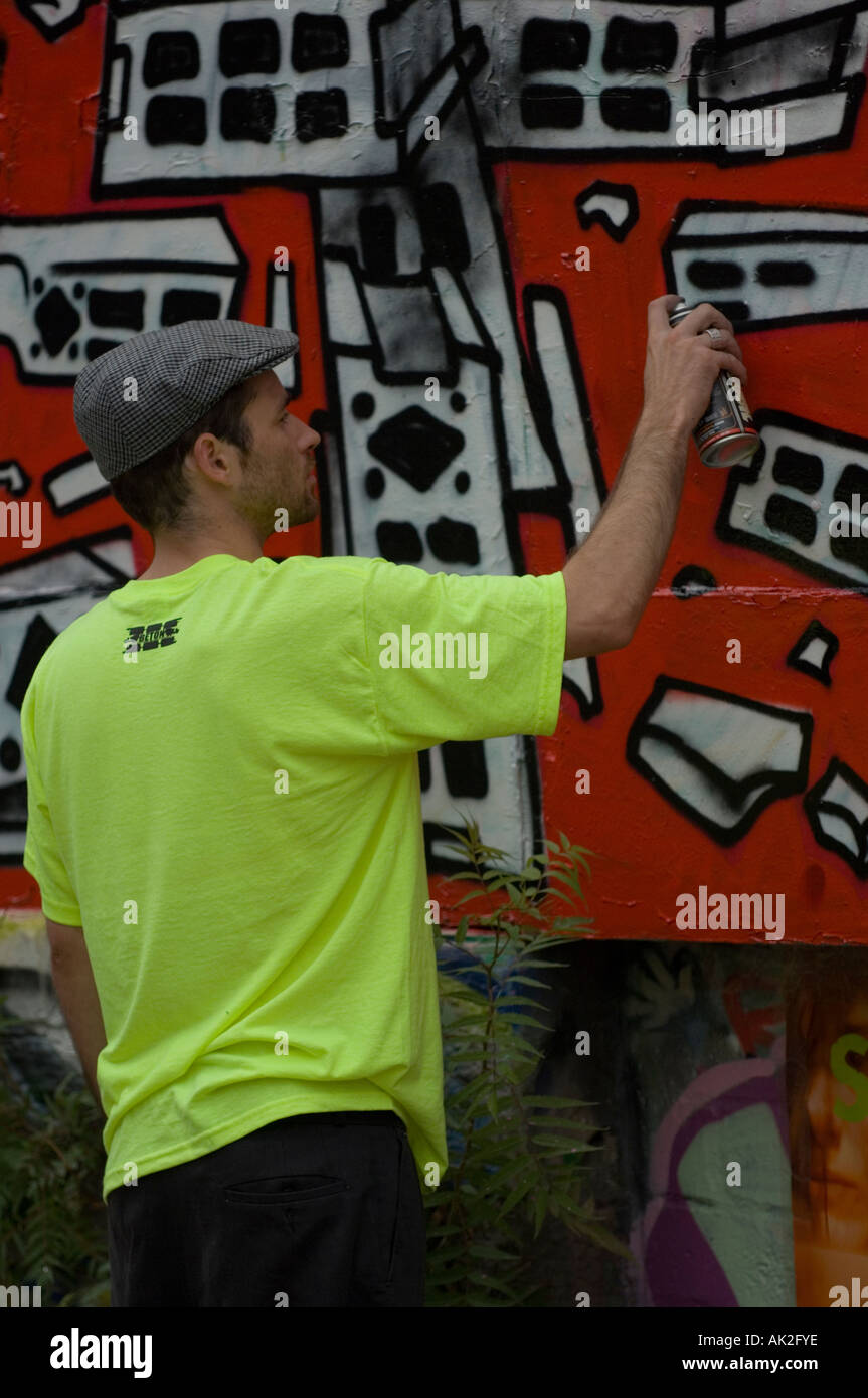 Actor of Renegade Theatre painting graffiti on a wall Stock Photo - Alamy