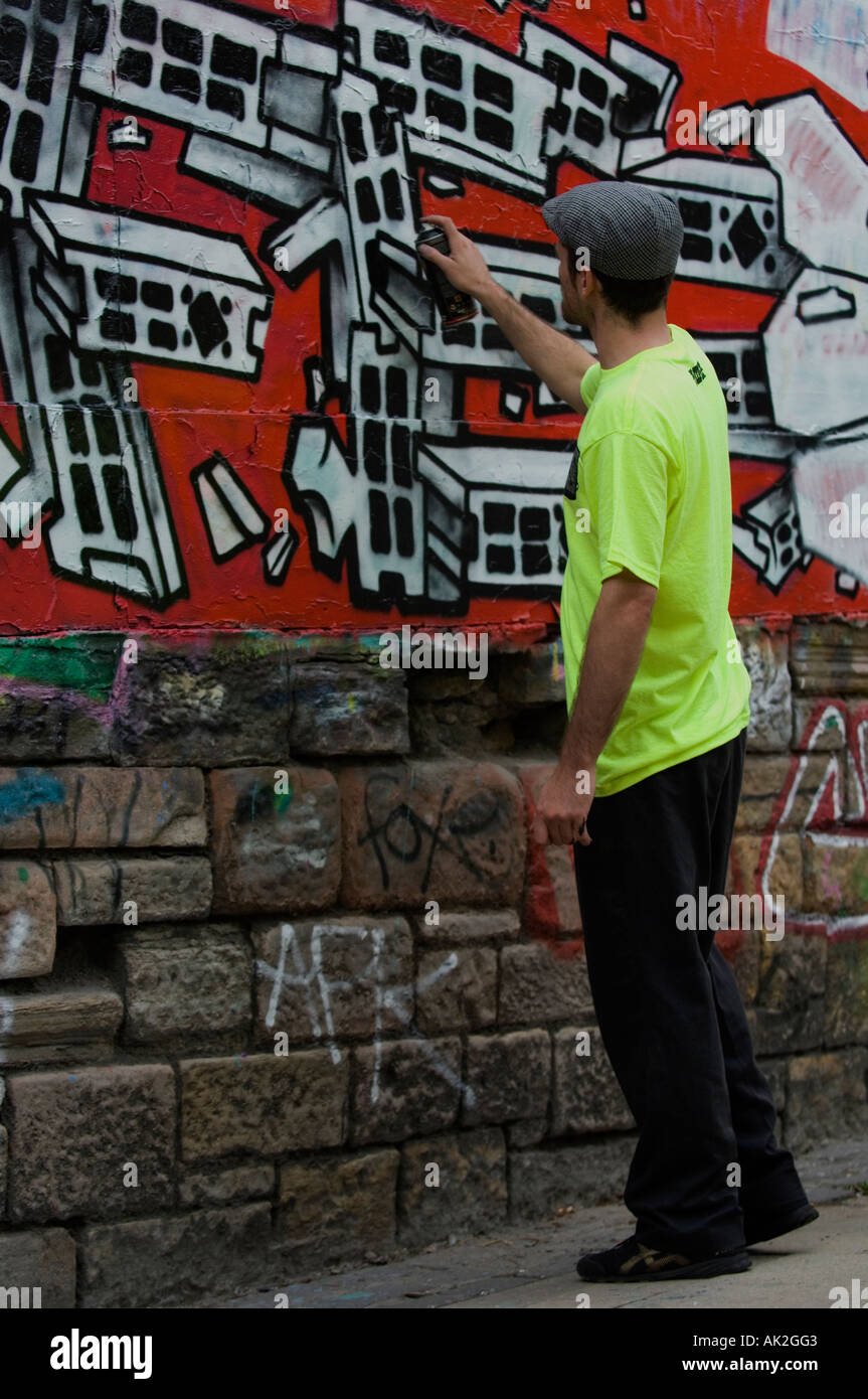 Actor of Renegade Theatre painting graffiti on a wall Stock Photo - Alamy