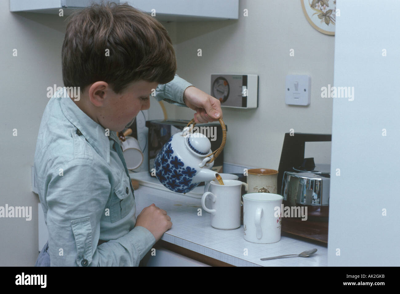 Boy making tea hi-res stock photography and images - Alamy