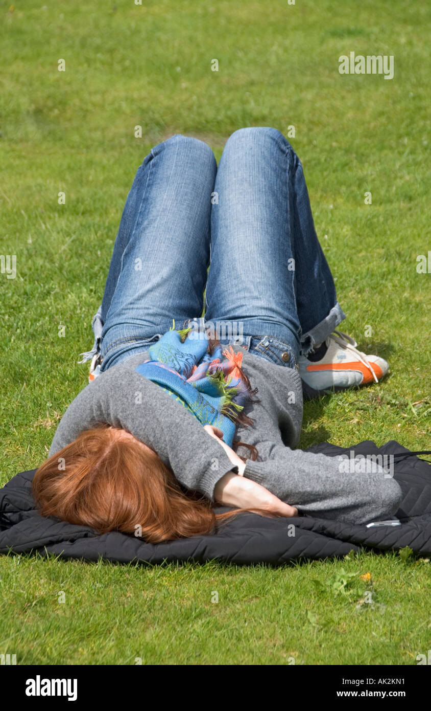 Ireland Dublin Castle Garden red head girl taking nap on lawn Stock ...