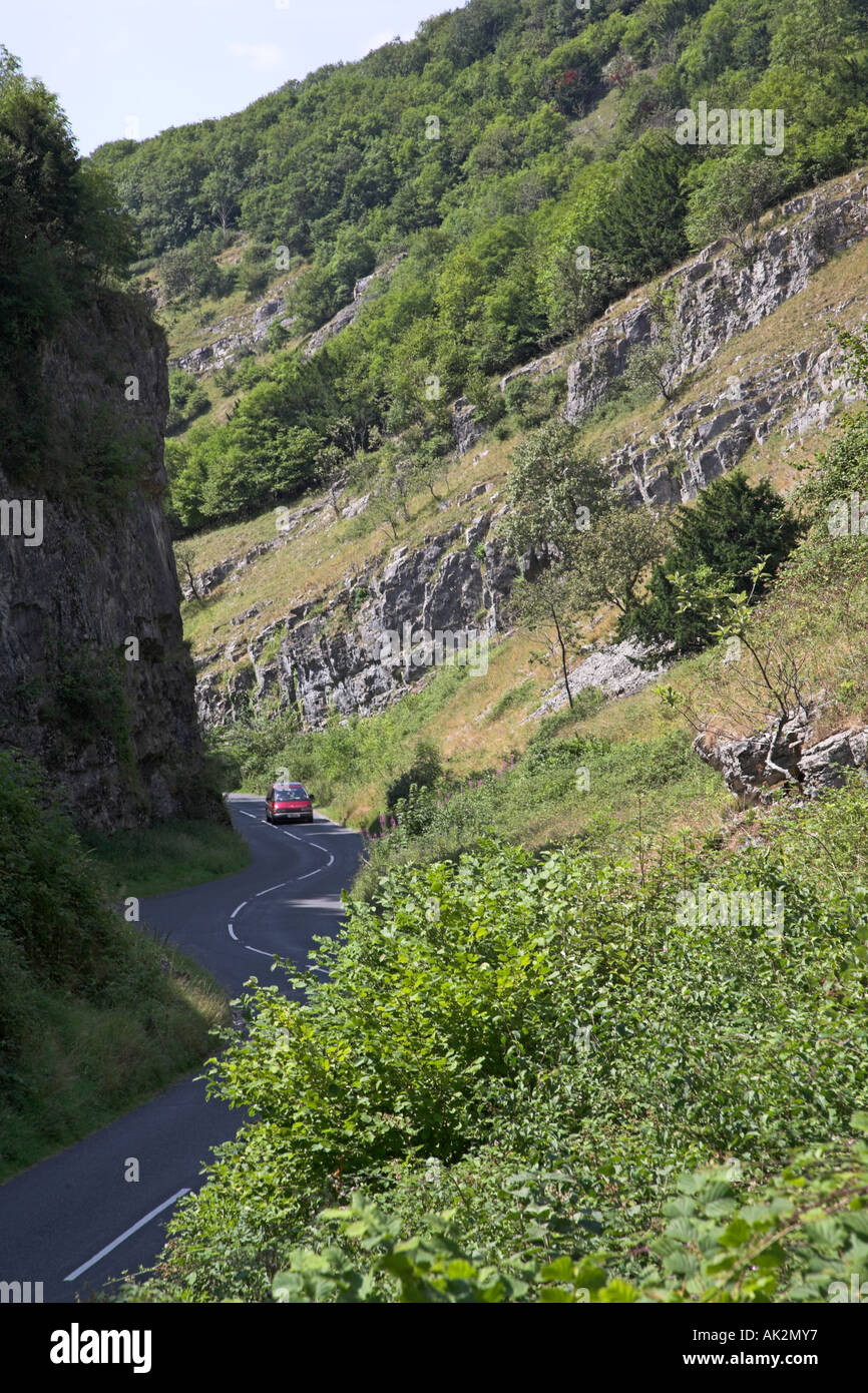 Red car driving through Cheddar Gorge Somerset England Stock Photo - Alamy