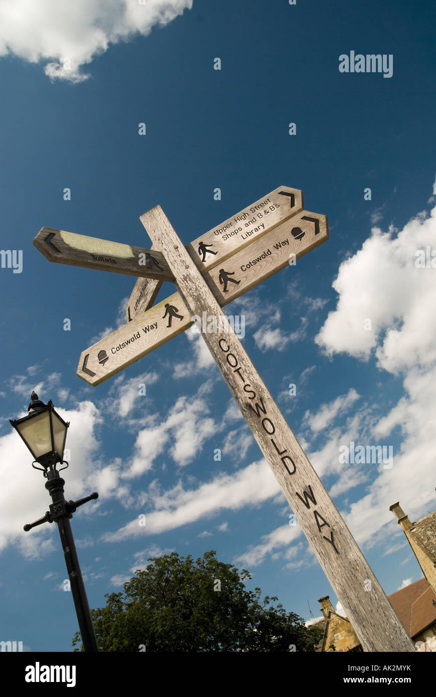 the well known village of broadway in the cotswolds with sign posts for ...