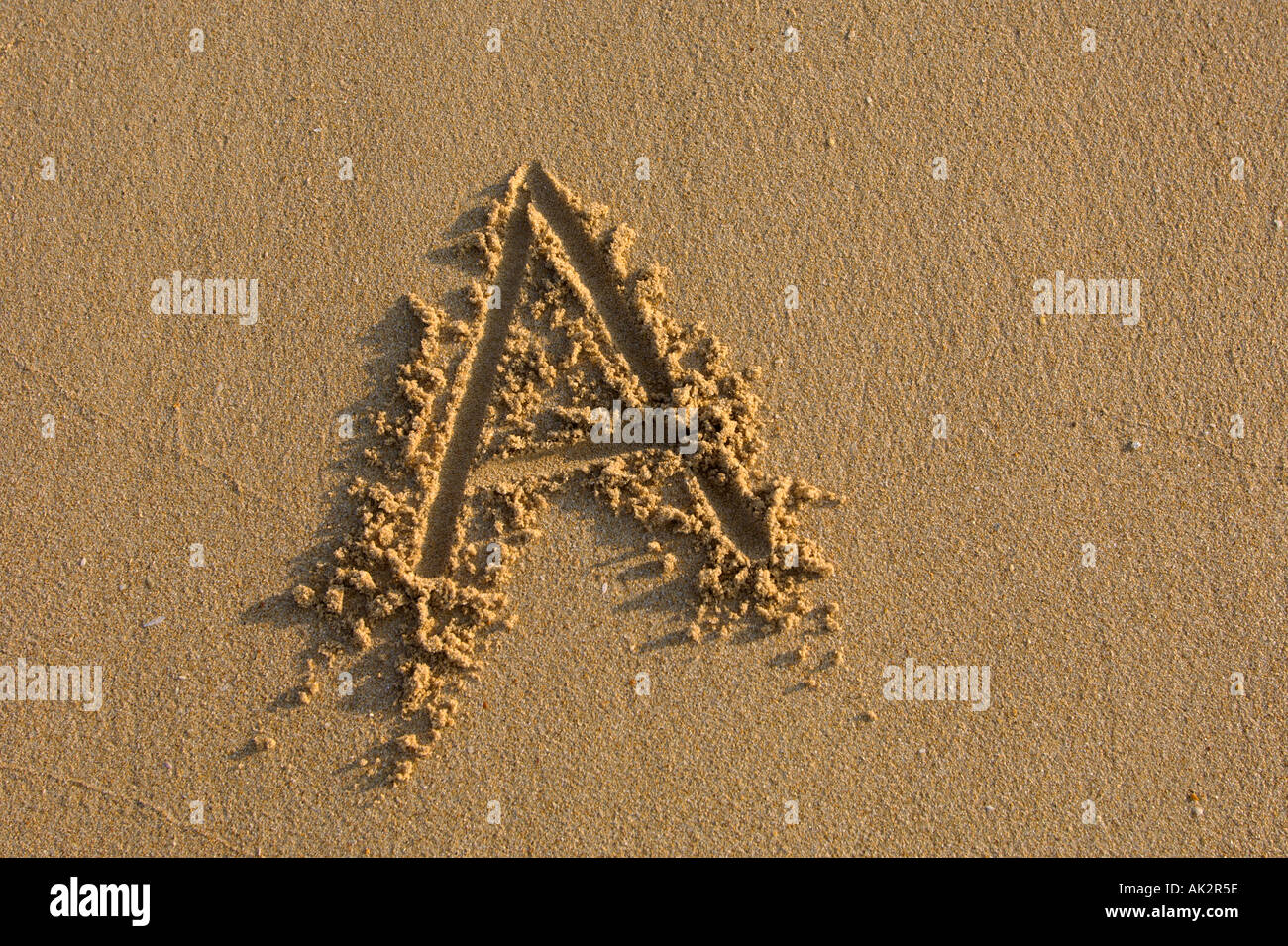 Alphabet writing on sand letter hi-res stock photography and images - Alamy