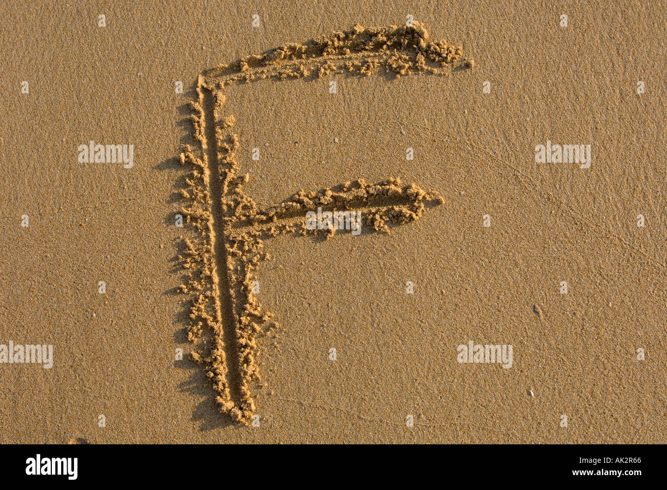 Alphabet writing on sand letter hi-res stock photography and images - Alamy