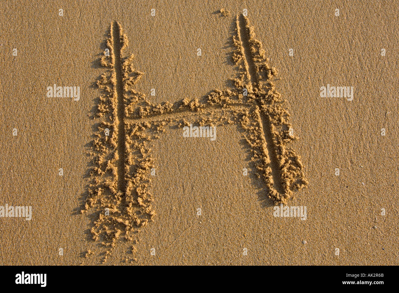 Alphabet hand writen letters on the sand Stock Photo - Alamy