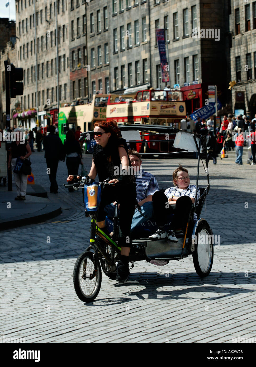 Rickshaw bicycle taxi carrying passengers in Edinburgh City Scotland ...