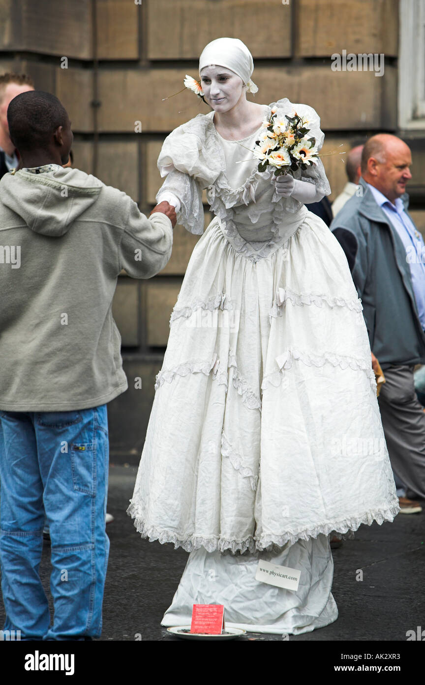 Young woman performing as a human statue during the Edinburgh Festival ...