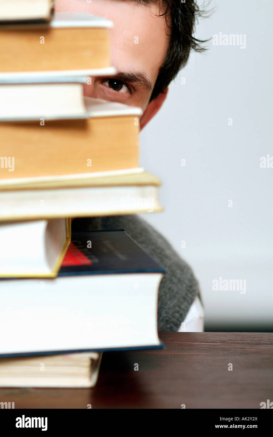 Man hidden behind books Stock Photo - Alamy