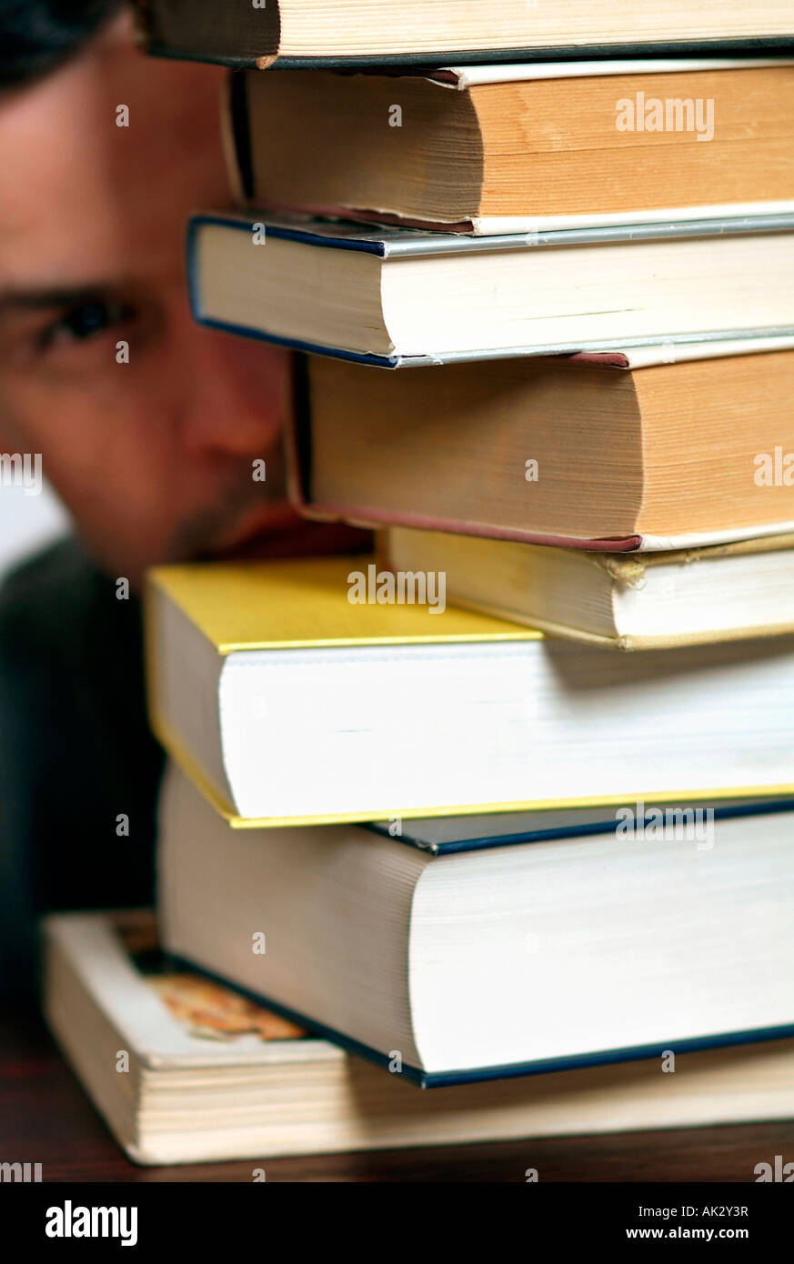 Man hidden behind books Stock Photo - Alamy