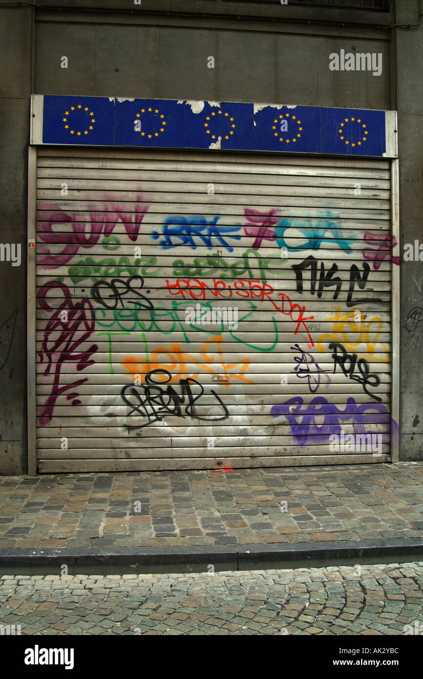 Colourful graffiti and tags on shop shutters that also feature EU ...