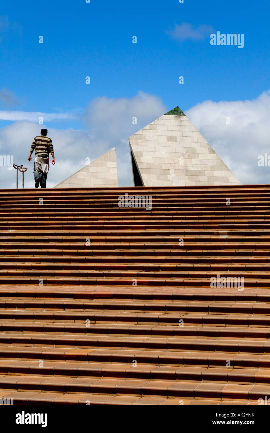 Man walking towards the stone pyramid sculpture in Civic Square ...