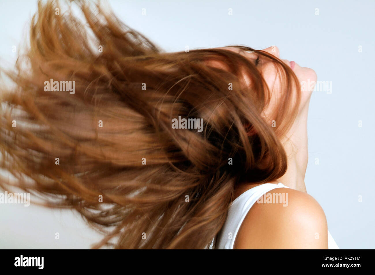 Young woman swinging her hair back Stock Photo - Alamy