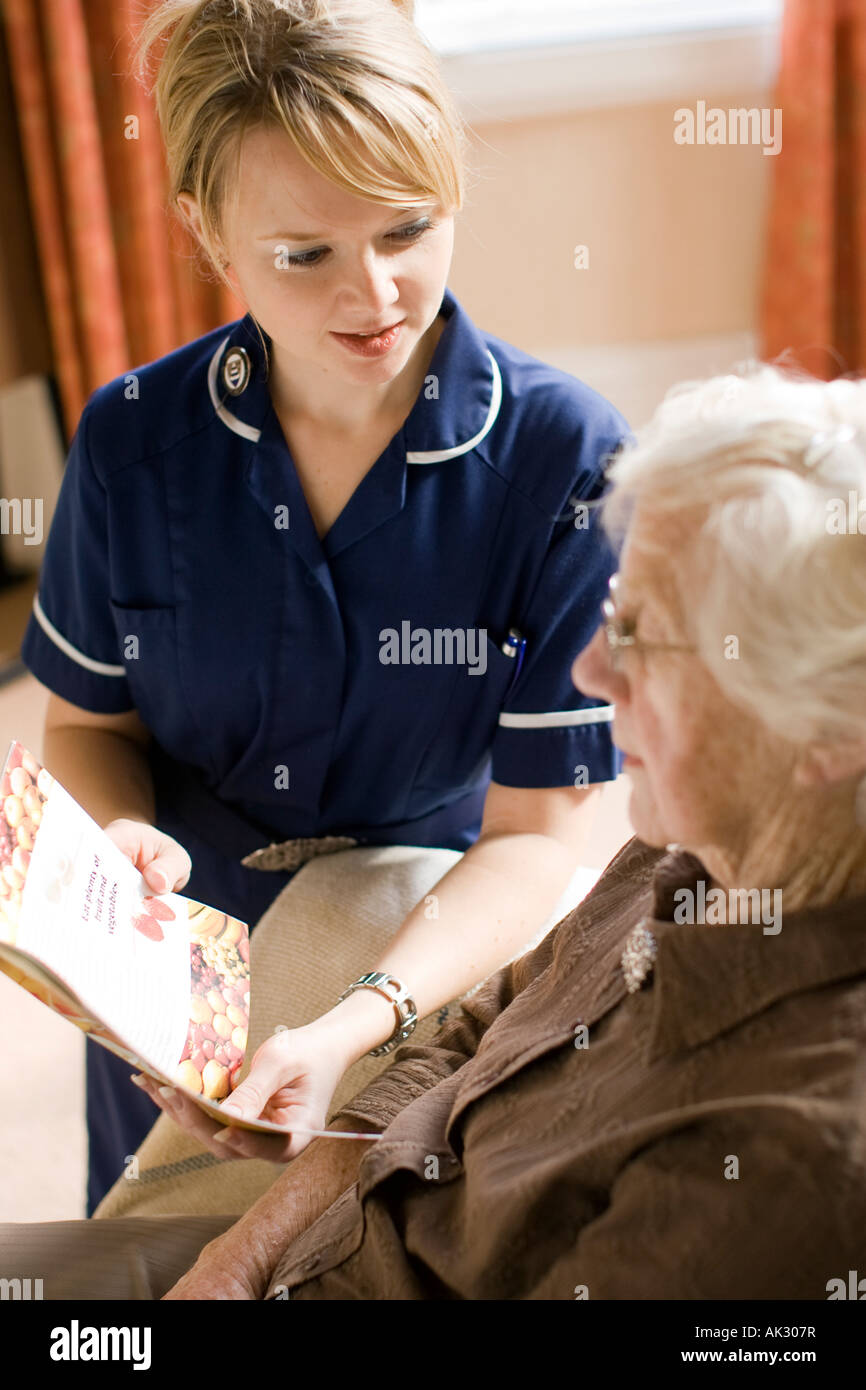 District nurse giving advice on home visit Stock Photo - Alamy