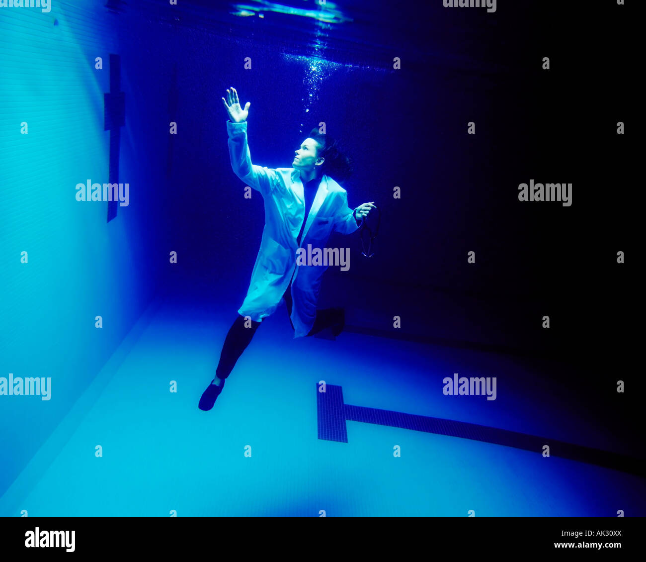 Woman dressed as a doctor underwater Stock Photo - Alamy