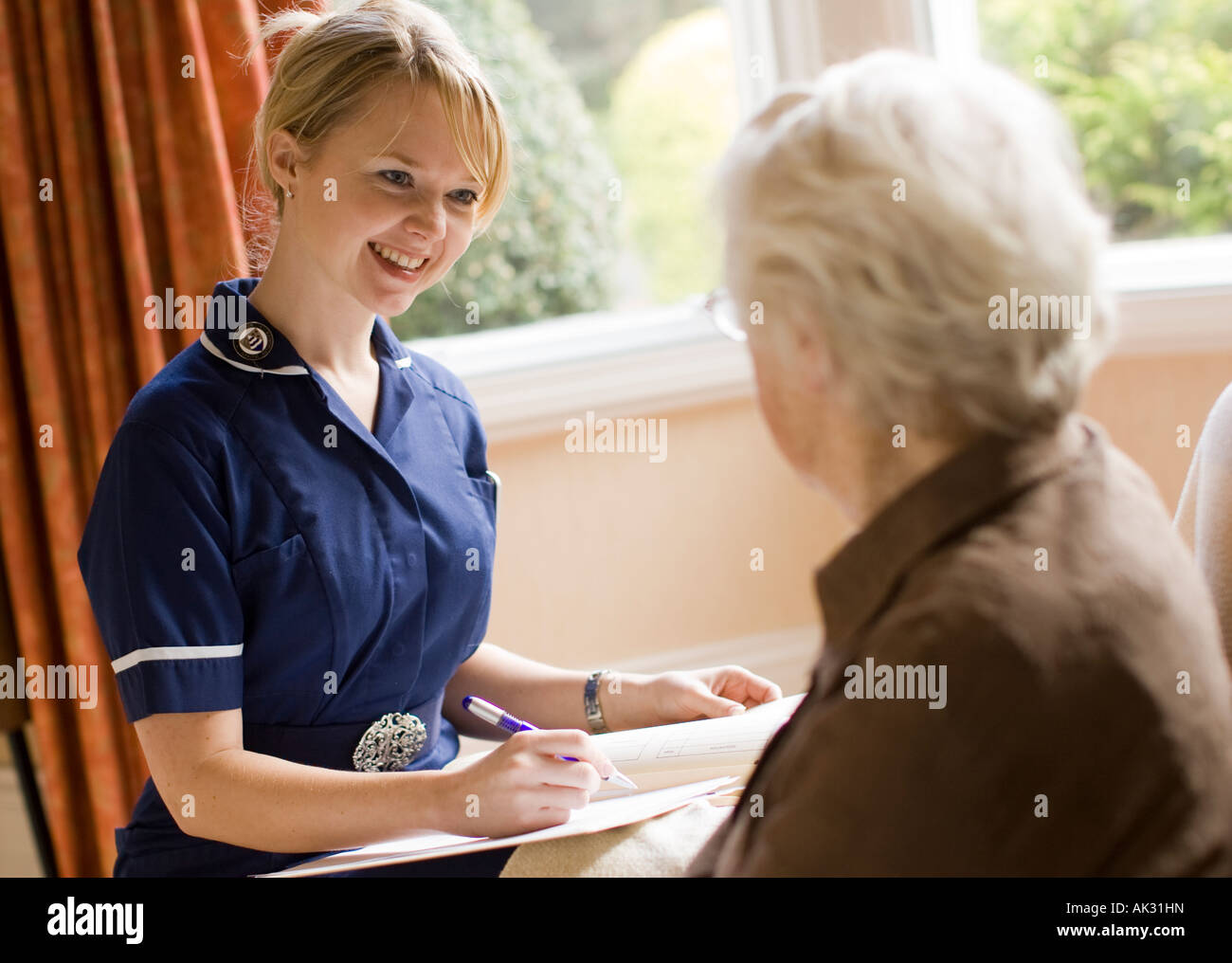District nurse giving advice on home visit Stock Photo - Alamy
