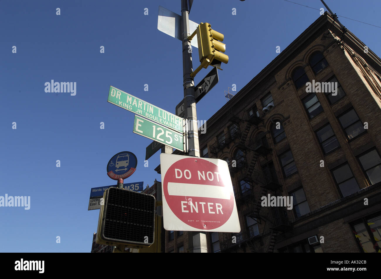 NY Harlem street signs buildings horizontal Stock Photo - Alamy