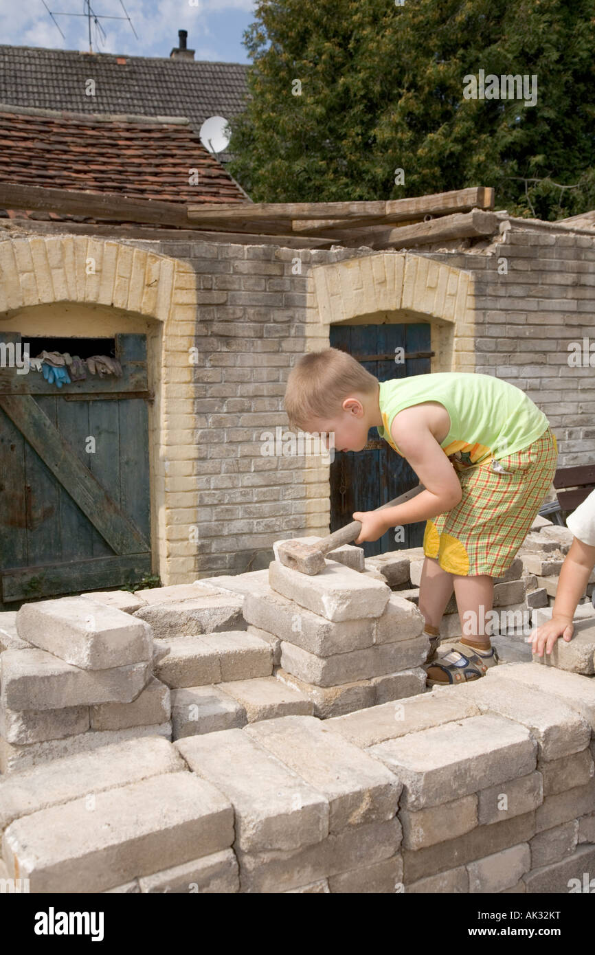 Boy near pile of bricks hi-res stock photography and images - Alamy